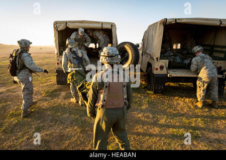 Airmen load simulated patient litters into Humvees at Joint Readiness ...