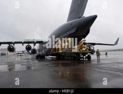U.S. Air Force personnel unload fire retardant from a C-130J Super ...