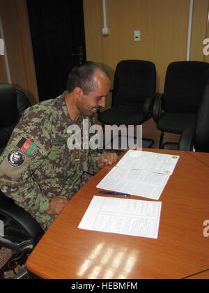 An Afghan Air Force 2nd Lieutenant signs a service commitment contract ...