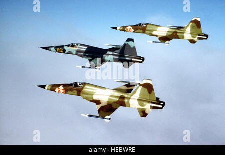 An air-to-air left side view of an F-5 Tiger II aircraft carrying AIM-9 ...