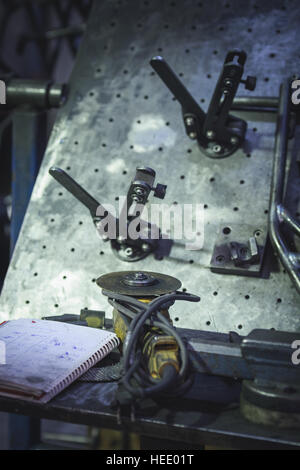 Hand tools and grinder on metal table Stock Photo - Alamy
