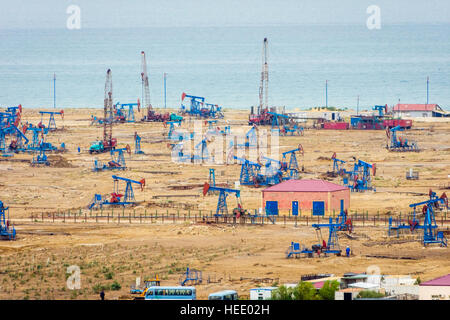 Oil pumps and rigs at the field by Caspian sea near Baku, Azerbaijan ...