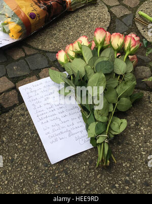 Floral tributes are left close to the scene where taxi driver Darren ...