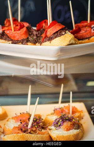 Tapas bar counter with assorted pincho tapas and a traditional ...