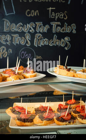 Tapas bar counter with assorted pincho tapas and a traditional ...