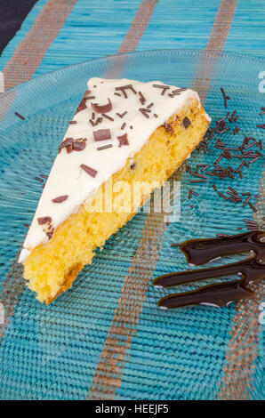 Lemon cake wedge with chocolate topping Stock Photo - Alamy