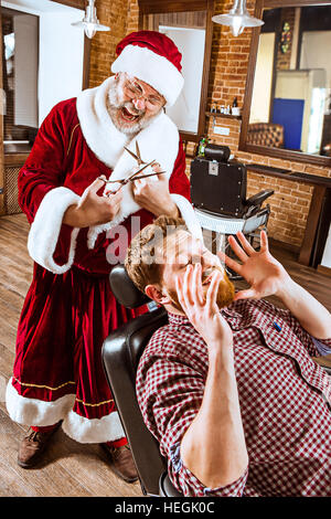 Santa claus as master at barber shop Stock Photo - Alamy