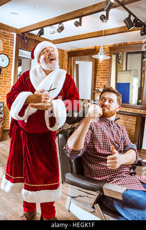 Santa claus as master at barber shop Stock Photo - Alamy