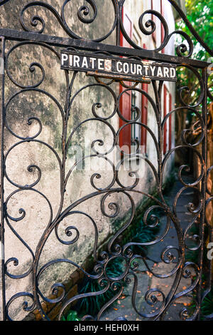 A grungy wrought iron gate to passageway at the Pirate House's ...