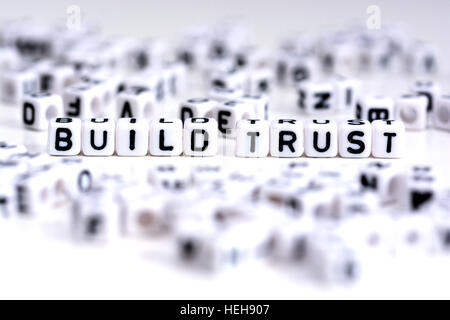 Build trust process concept with tiled letters on white background ...