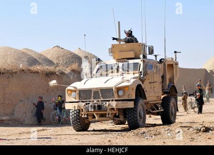 U.S. Army Soldiers patrol through an orchard during a joint cordon and ...