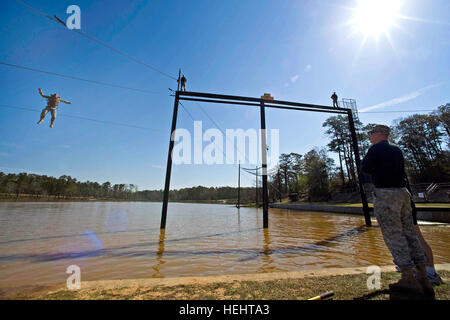 A Ranger Cadre watches a trainee drop 40 feet into a lake during his ...