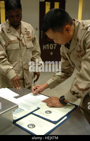 A Navy Expeditionary Guard Battalion member conducts an M-9 pistol ...