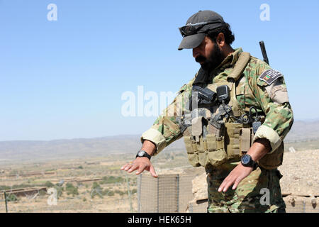 Afghan National Police Commander Azizullah uses the scope on his rifle ...