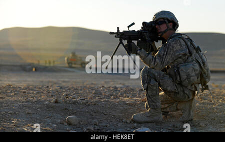 Spc. Christopher Keefe pulls security on a hilltop while mechanics look ...