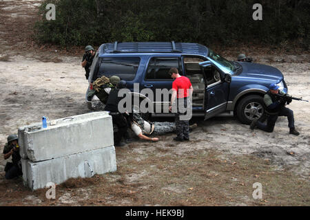 SWAT team members armed with service rifles, standing in stack ...