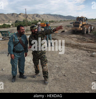 Afghan Local Police Cmdr. Aziz directs the heavy machine operation ...
