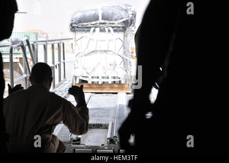 A loadmaster from the 702nd Expeditionary Airlift Squadron supervises ...