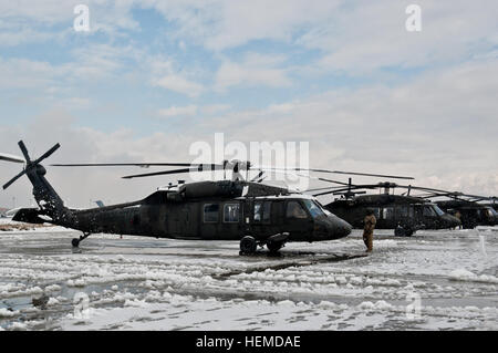 Snow flies up as a U.S. Army CH-47 Chinook helicopter prepares to land ...