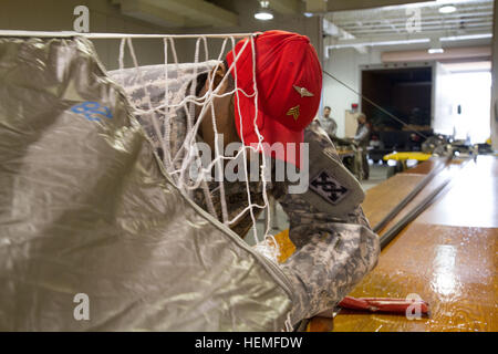 An Army Reserve parachute rigger with the 824th Quartermaster Company ...