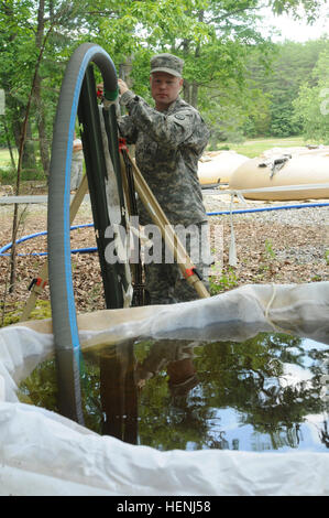 Soldiers from the 326th Quartermaster Company prepare water pumps and ...