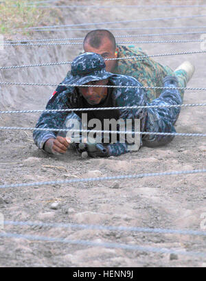A Costa Rican special operations team member prepares his pistol before ...