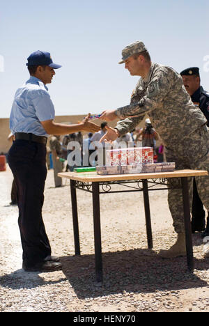 Col. Peter Baker, commander of the 214th Fires Brigade, shakes hands ...