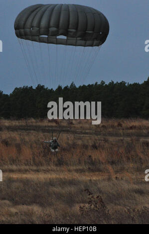 A U.S. Army paratrooper lands on Luzon Drop Zone after jumping out of a ...