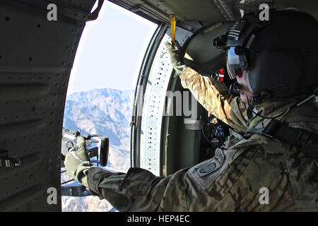A UH-60 helicopter door gunner provides security as helicopters fly ...