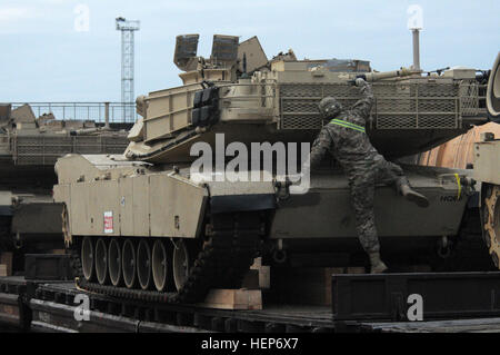 A US Army M1A2 Abrams tank fires a sabot round during annual gunnery ...