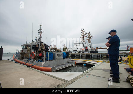 A Coast Guard 27-foot Special Purpose Craft-Shallow Water boat crew and ...