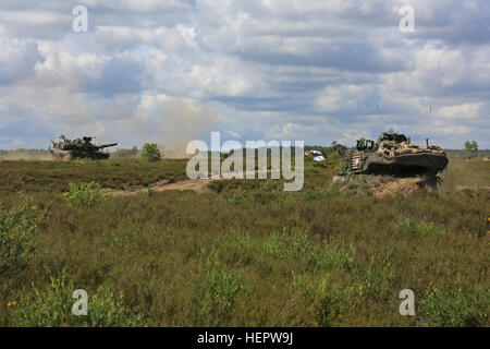 Soldiers assigned to 1st Armored Division move target area during the ...