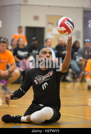 Team Army competes in a sitting volleyball match against Team United ...