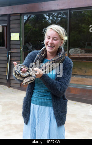 Woman with a snake around her neck Stock Photo - Alamy