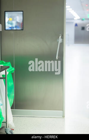 Operating theater surgery trash bin and nurse with green plastic bag ...