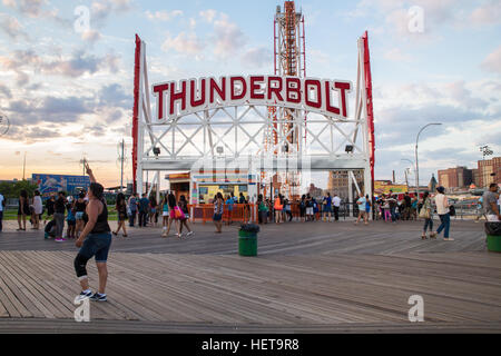 View of Coney Island Boardwalk with rides and people visible Stock ...