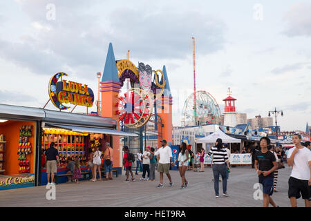 View of Coney Island Boardwalk with rides and people visible. Brooklyn ...
