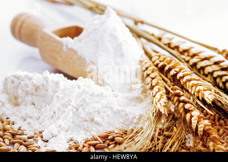 Wooden spoon with flour wheat ear on black background Stock Photo - Alamy