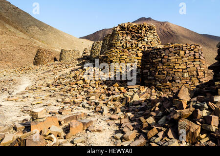 Ancient handmade stone burial mounds and tombs atop a desert ridge ...