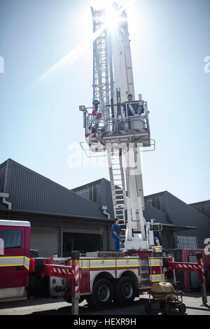 Mechanics maintaining fire engine Stock Photo - Alamy