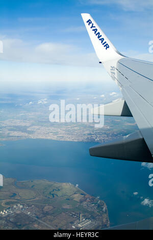 Ryanair airplane wing viewed from inside the cabin through the window ...