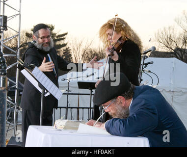 Sofer (Jewish ritual scribe) Shaul Bassel, lower center, inscribes word ...