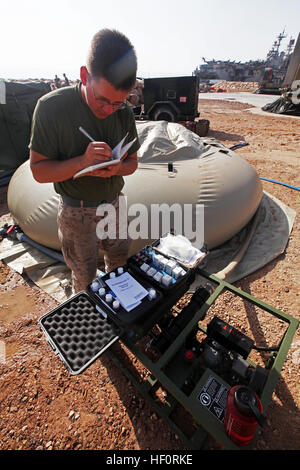 AQABA, Jordan - Lance Cpl. Scott Clark, a water purification specialist ...