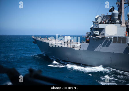 USS Harris and USS Peleliu conduct a ship-to-ship refueling exercise to ...