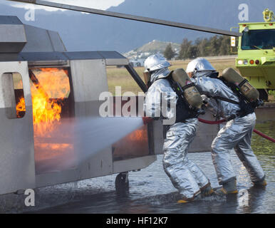 Crash Fire Rescue Marines work together to spray a mock helicopter ...