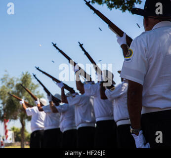 The honor guard performs a gun salute at the funeral of a veteran of ...