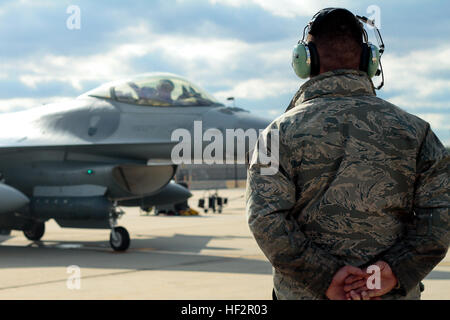 F-16 Crew Chief, Senior Airman Adam Flood, conducts pre-flight checks ...