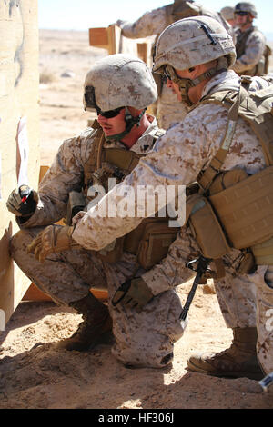 Marines from Weapon Platoon, Co. 3/4, launch mortars at enemy troops ...