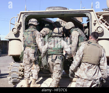 U.S. Corpsmen carry a wounded Marine on a stretcher to an evacuation ...