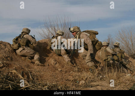 Soldiers take cover behind a berm after making contact with the enemy ...